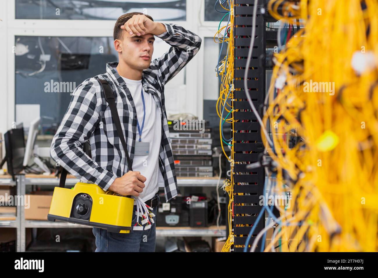 Tired network engineer with box working ethernet switches Stock Photo ...