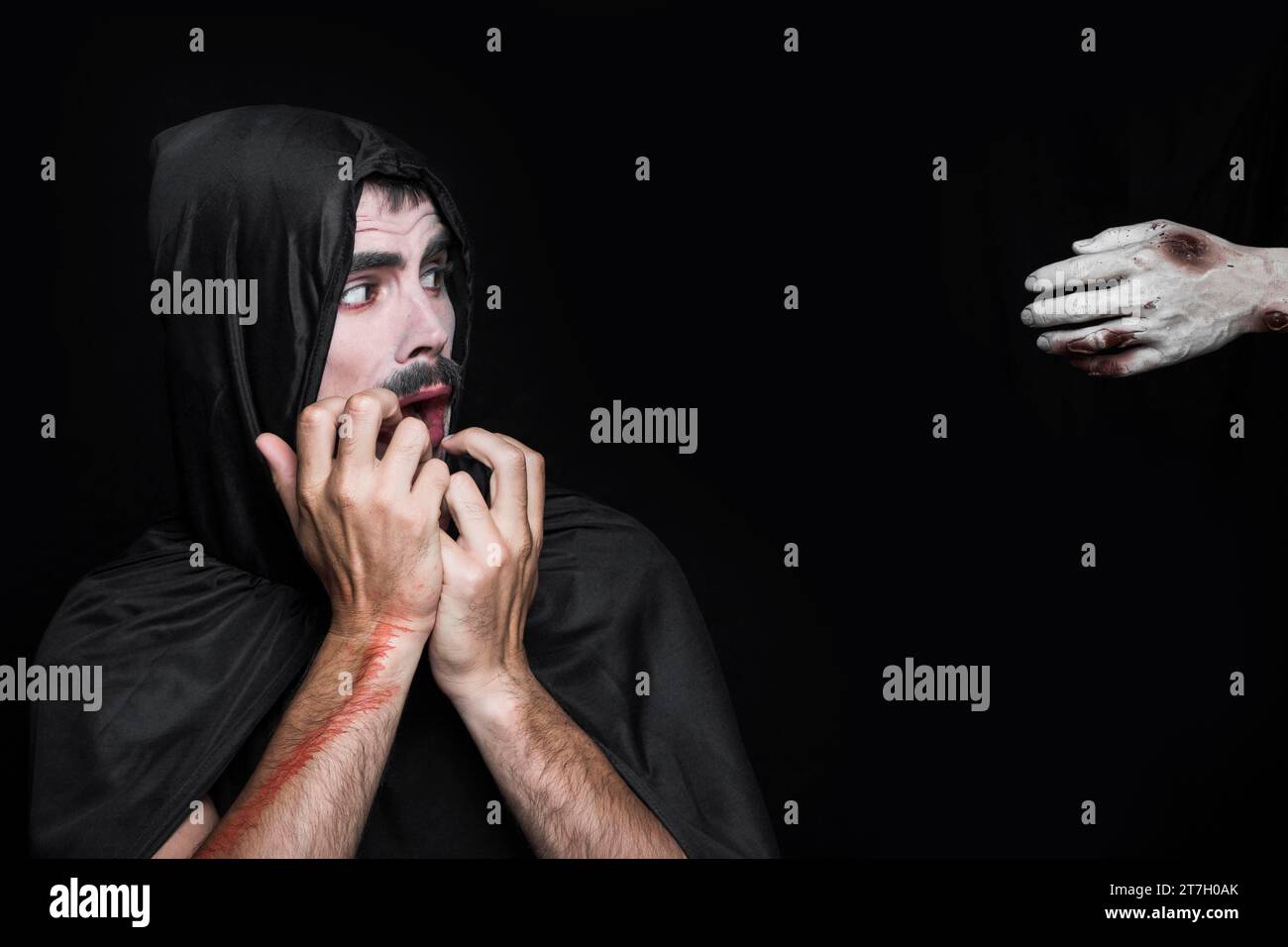 Young man halloween costume looking corpse hand Stock Photo - Alamy