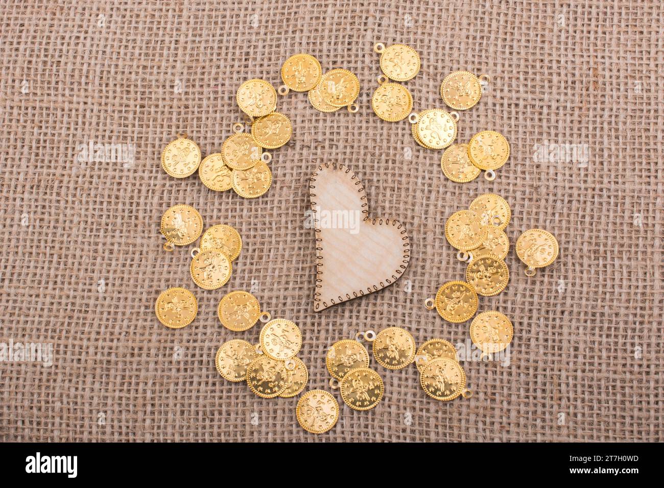 Fake gold coins around heart shape made of paper Stock Photo - Alamy