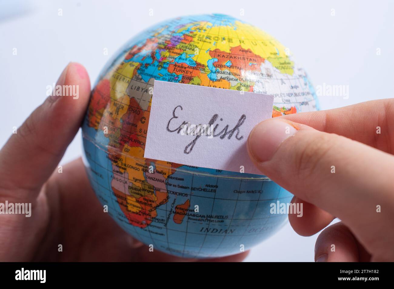 Hand holding notepaper with English wording on model globe Stock Photo ...