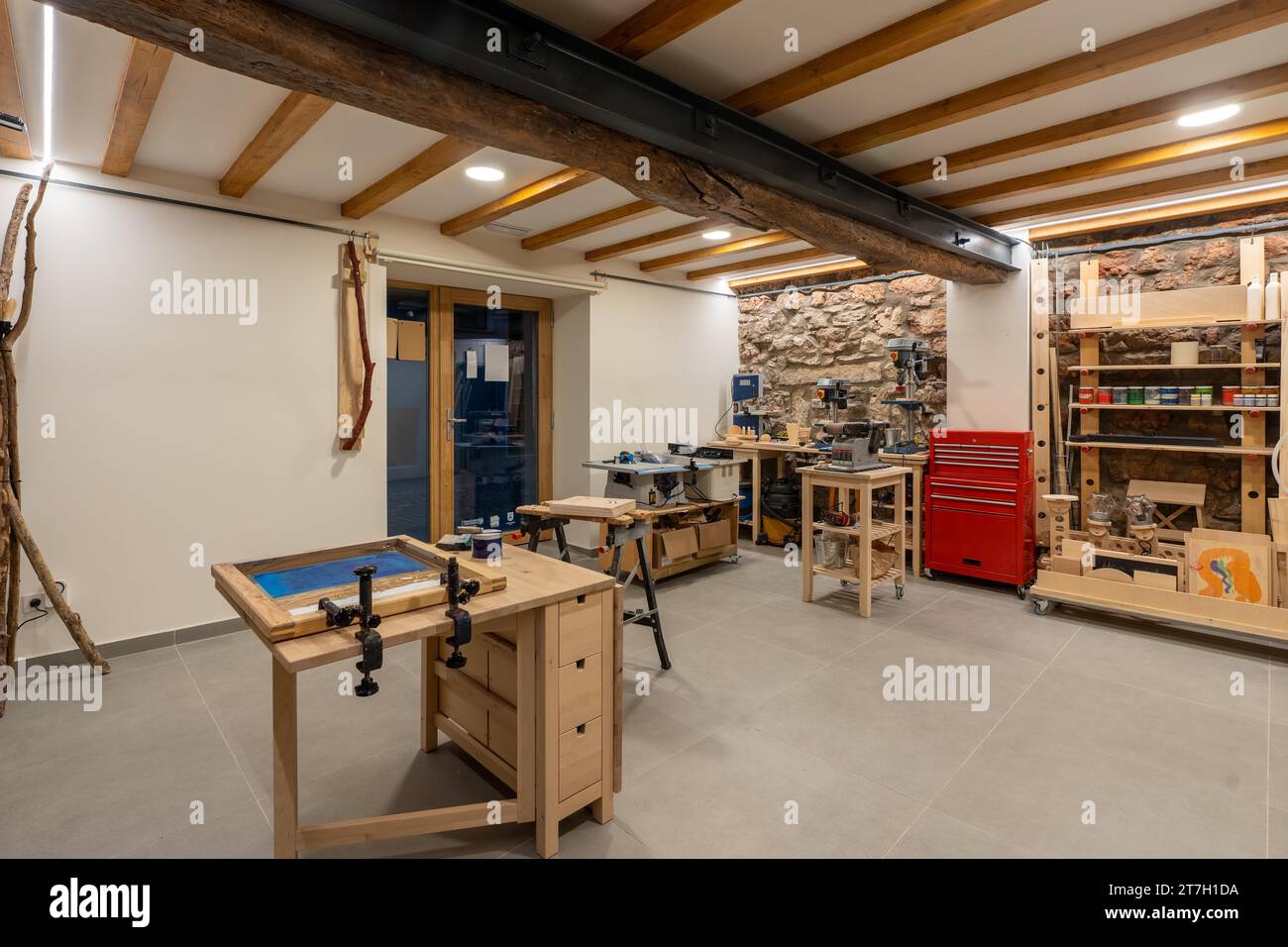 Interior space of a screen printing studio with different tables to ...