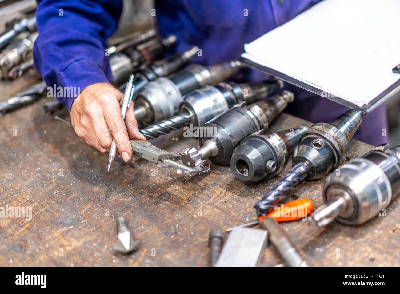 Factory worker operator of the numerical control sector measuring the ...
