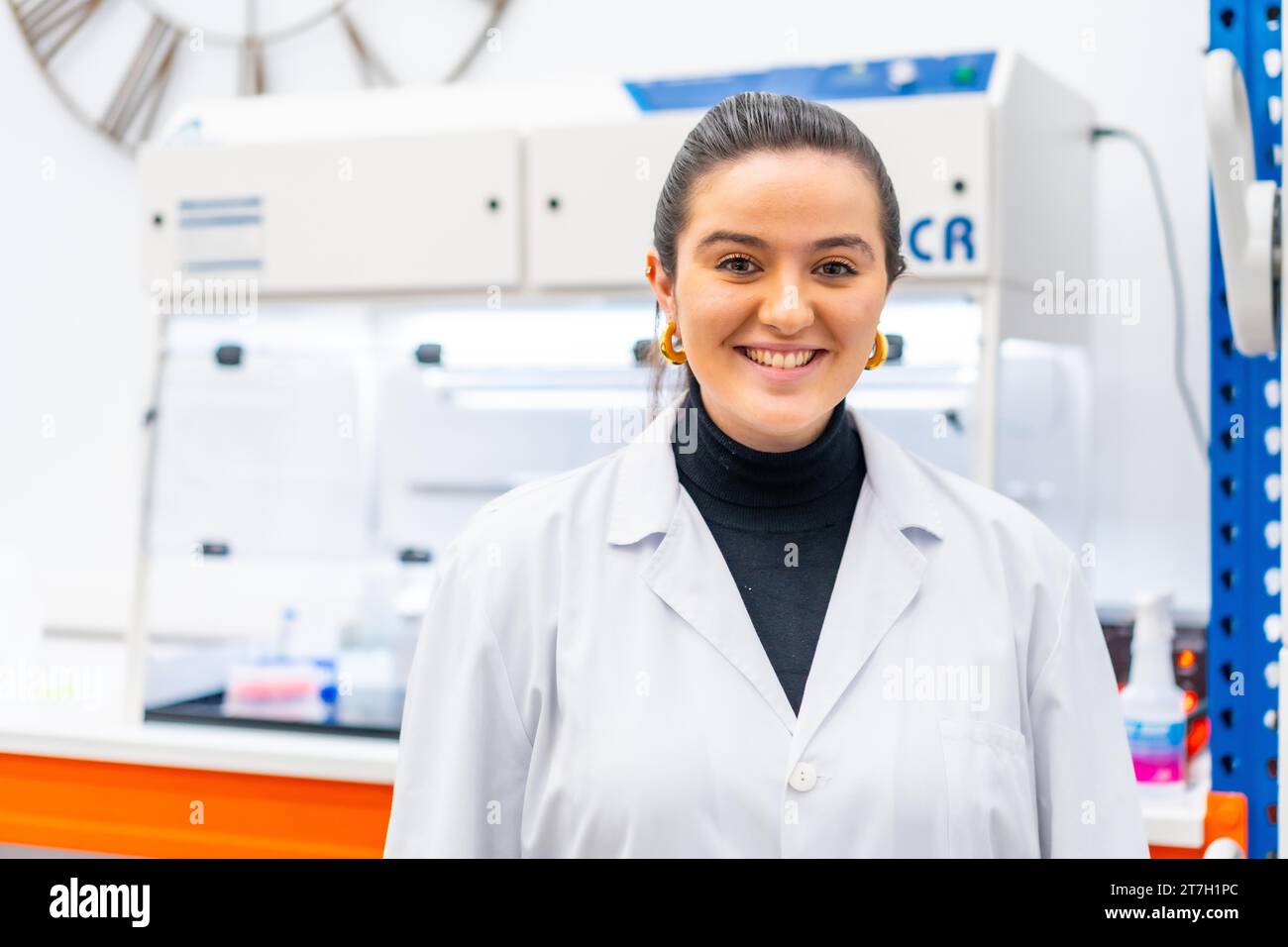 Portrait of a young scientist standing smiling in a laboratory Stock ...