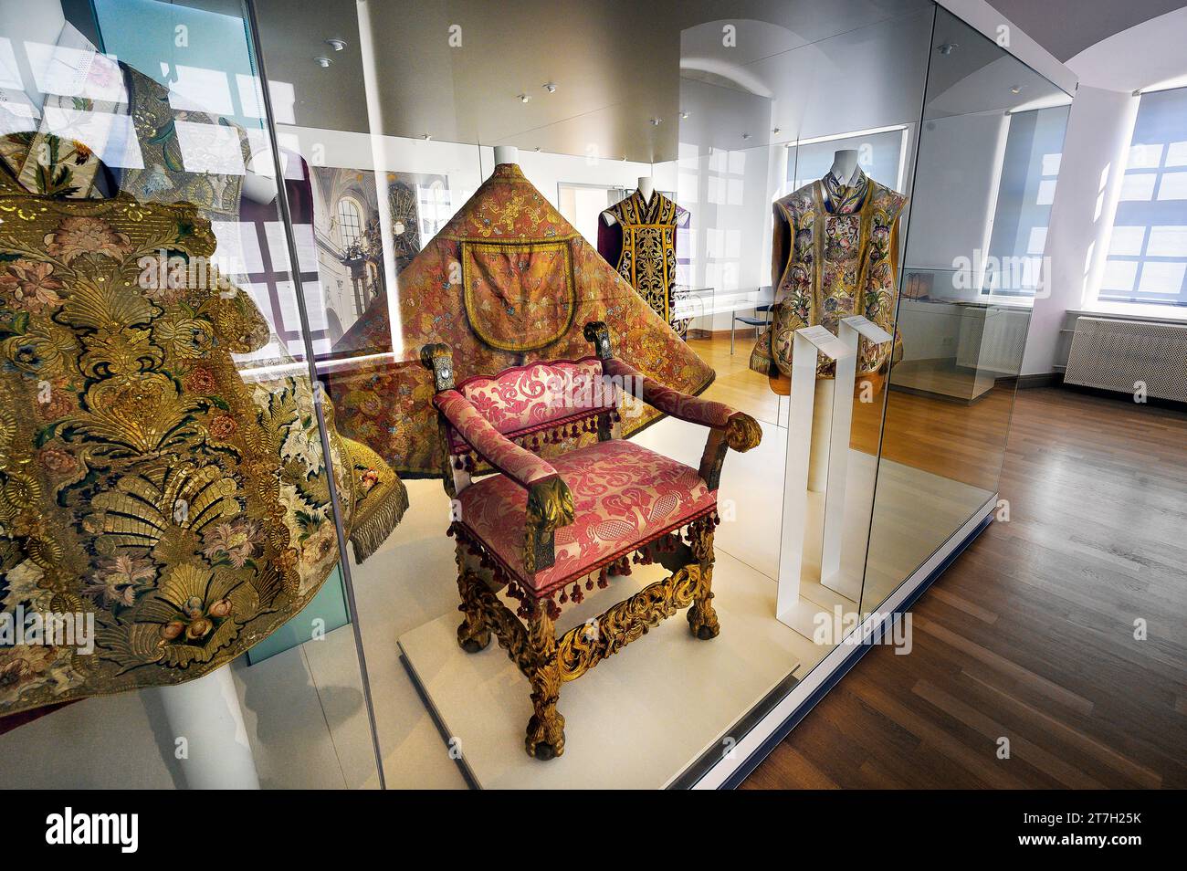 Liturgical vestments and richly carved upholstered chair in the ...