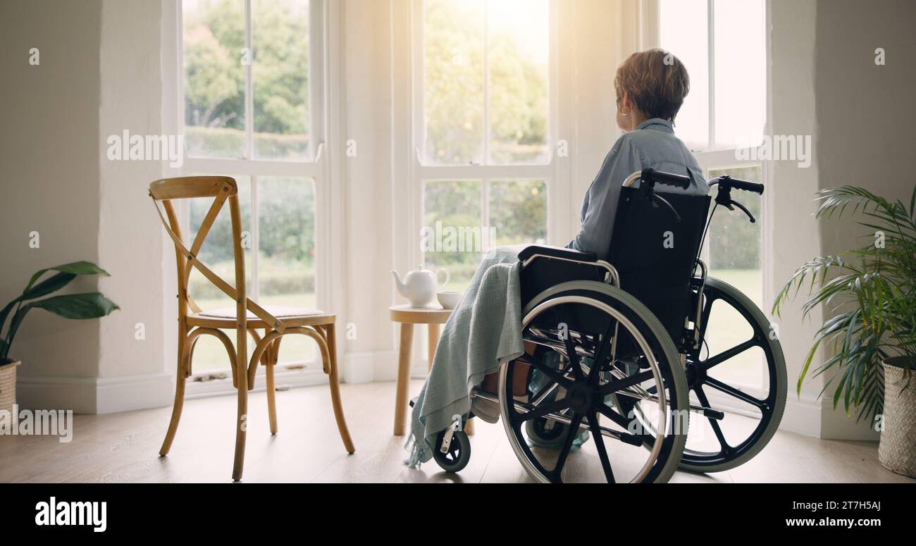 Wheelchair, old woman or thinking and lonely by window in nursing home or retirement with ...