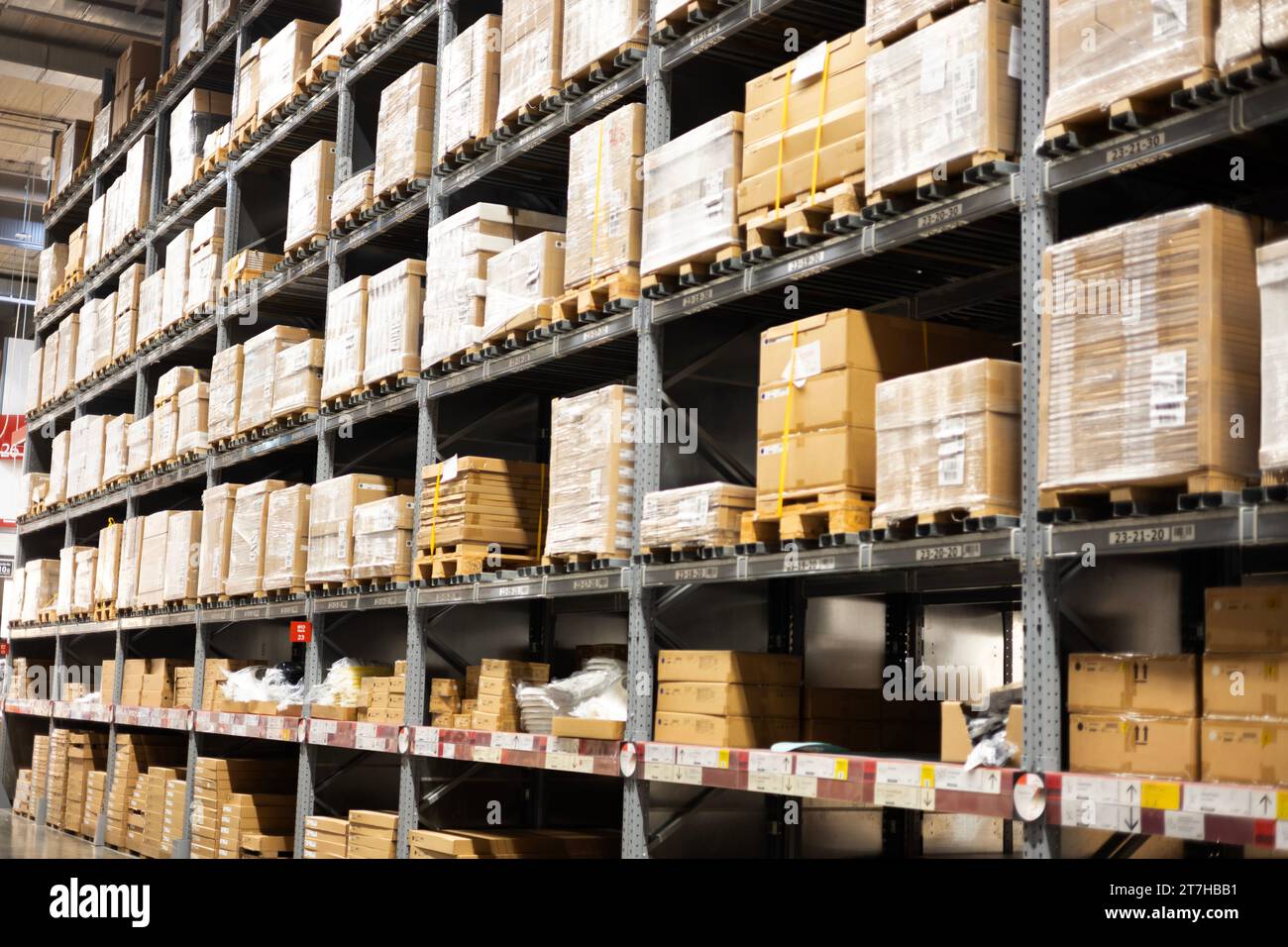 Rows of shelves with boxes in factory warehouse. Interior Of Warehouse ...