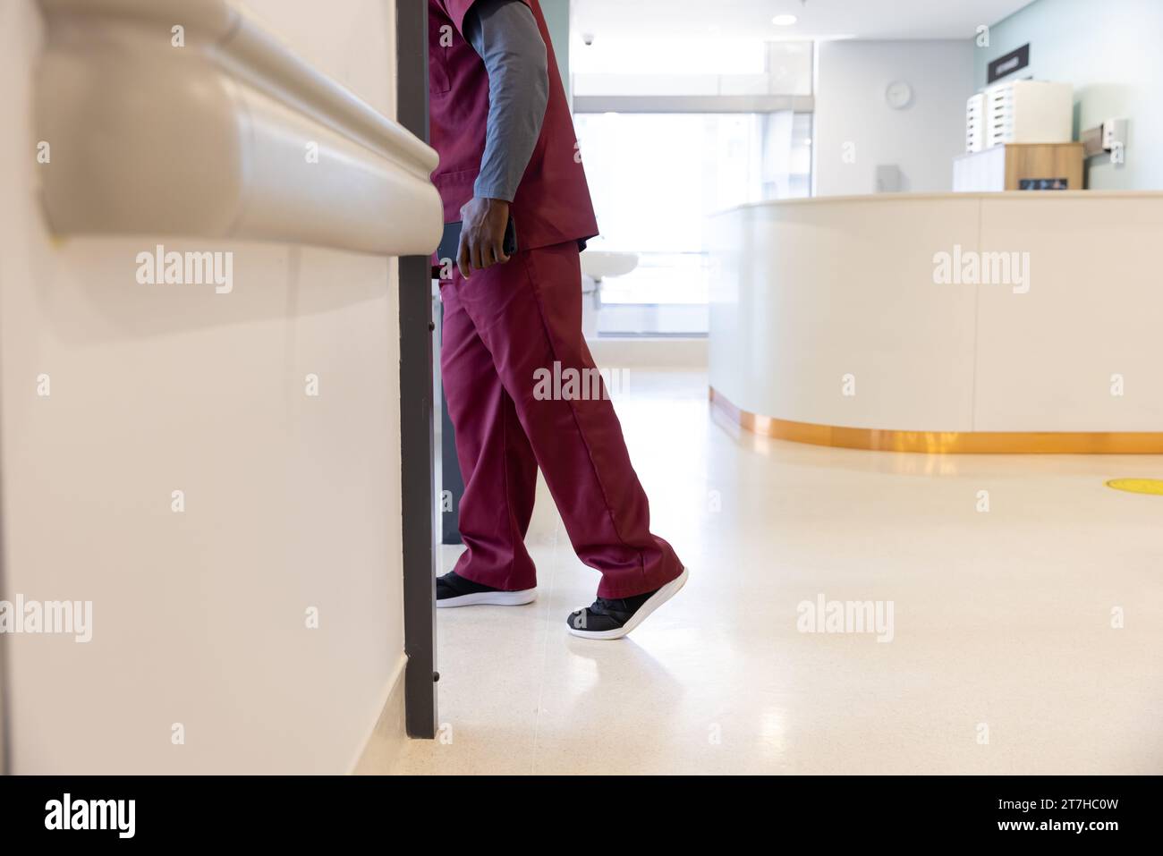 Lowsection of african american male doctor walking in hospital corridor ...