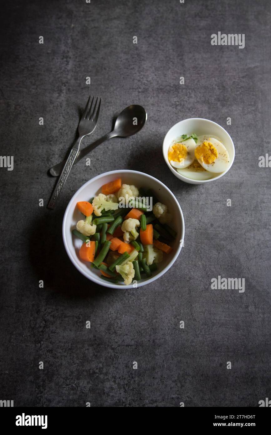 Healthy food boiled vegetables and boiled eggs served Stock Photo - Alamy