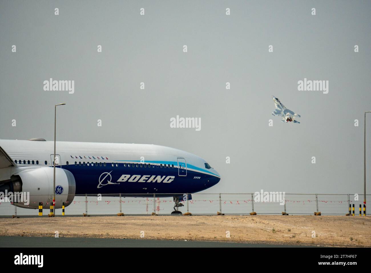 A Boeing 777 infront of a departing military plane F-15 at the Dubai ...