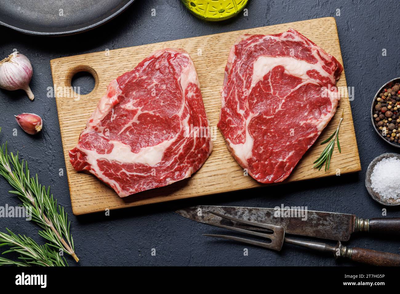 Raw ribeye steaks with savory spices. Flat lay Stock Photo - Alamy