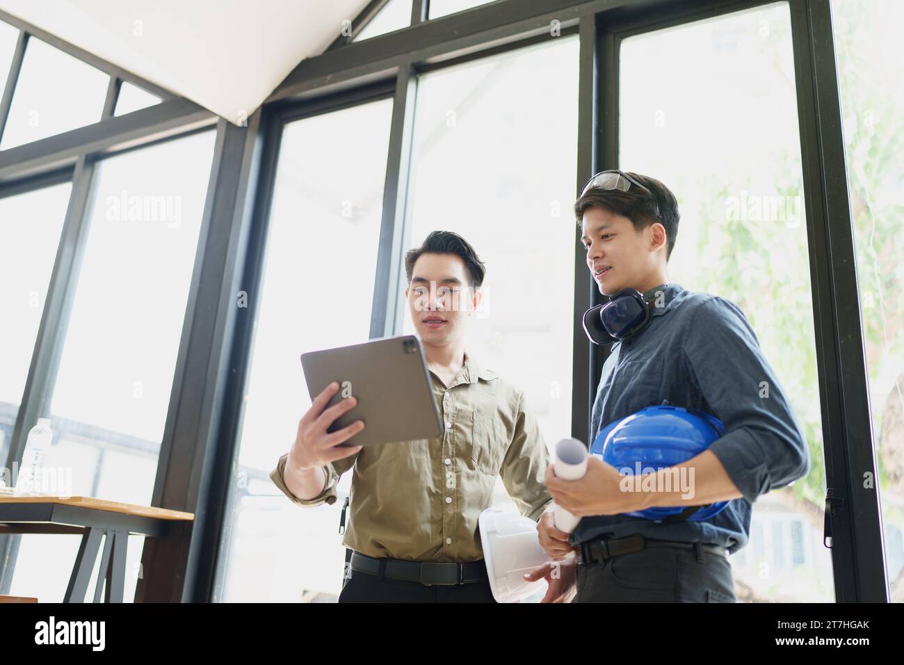 multi ethnic engineer brainstorming and measuring for cost estimating ...