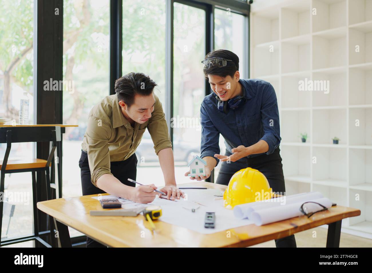multi ethnic engineer brainstorming and measuring for cost estimating ...