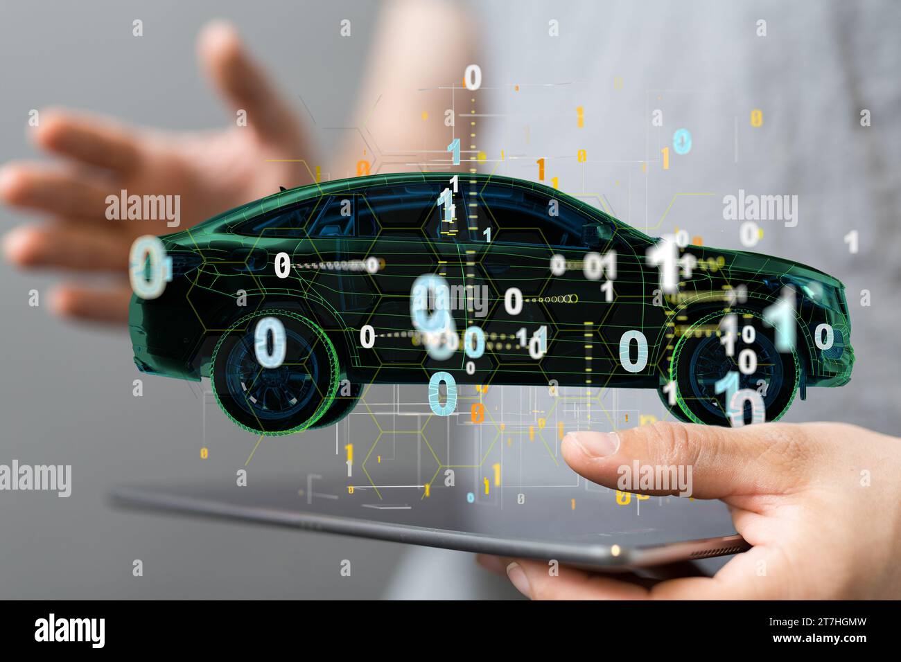 A holographic car with binary numbers hovering above a tablet Stock ...