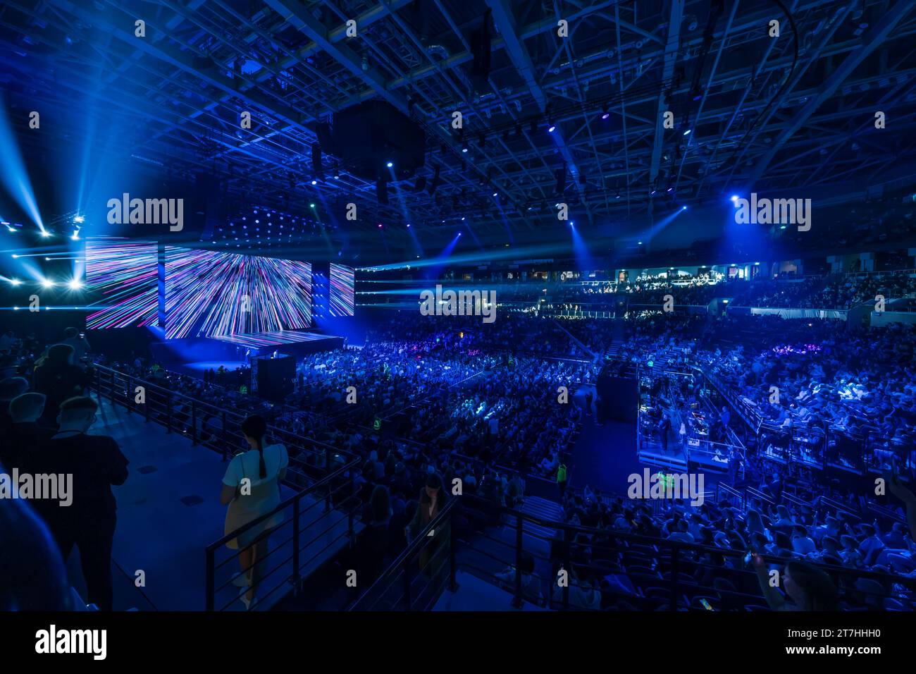 Aerial view of business crowd attending concert in huge illuminated ...