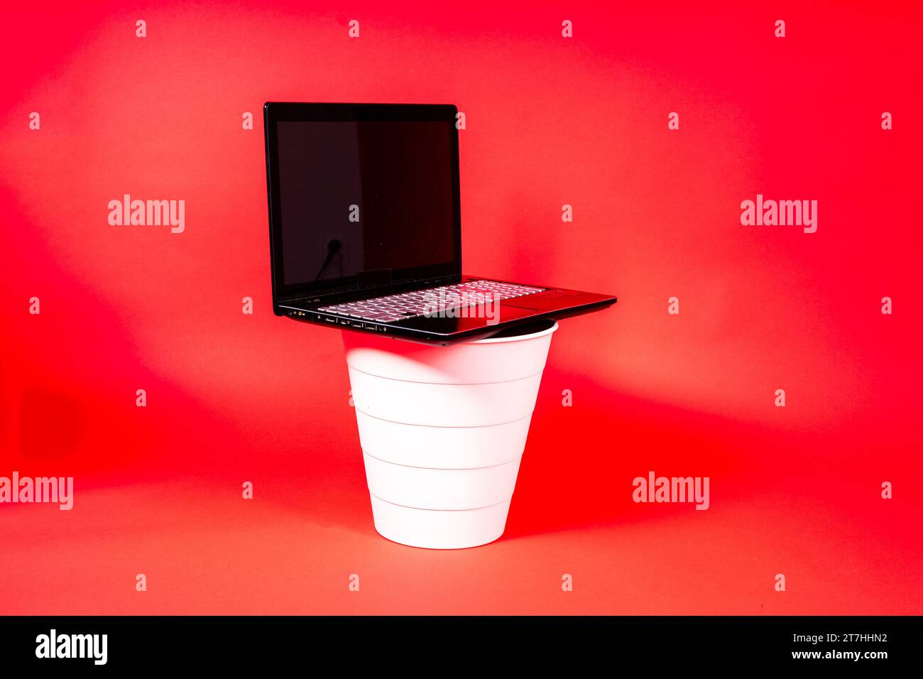 Black laptop in a trash bin on a red background isolated Stock Photo ...