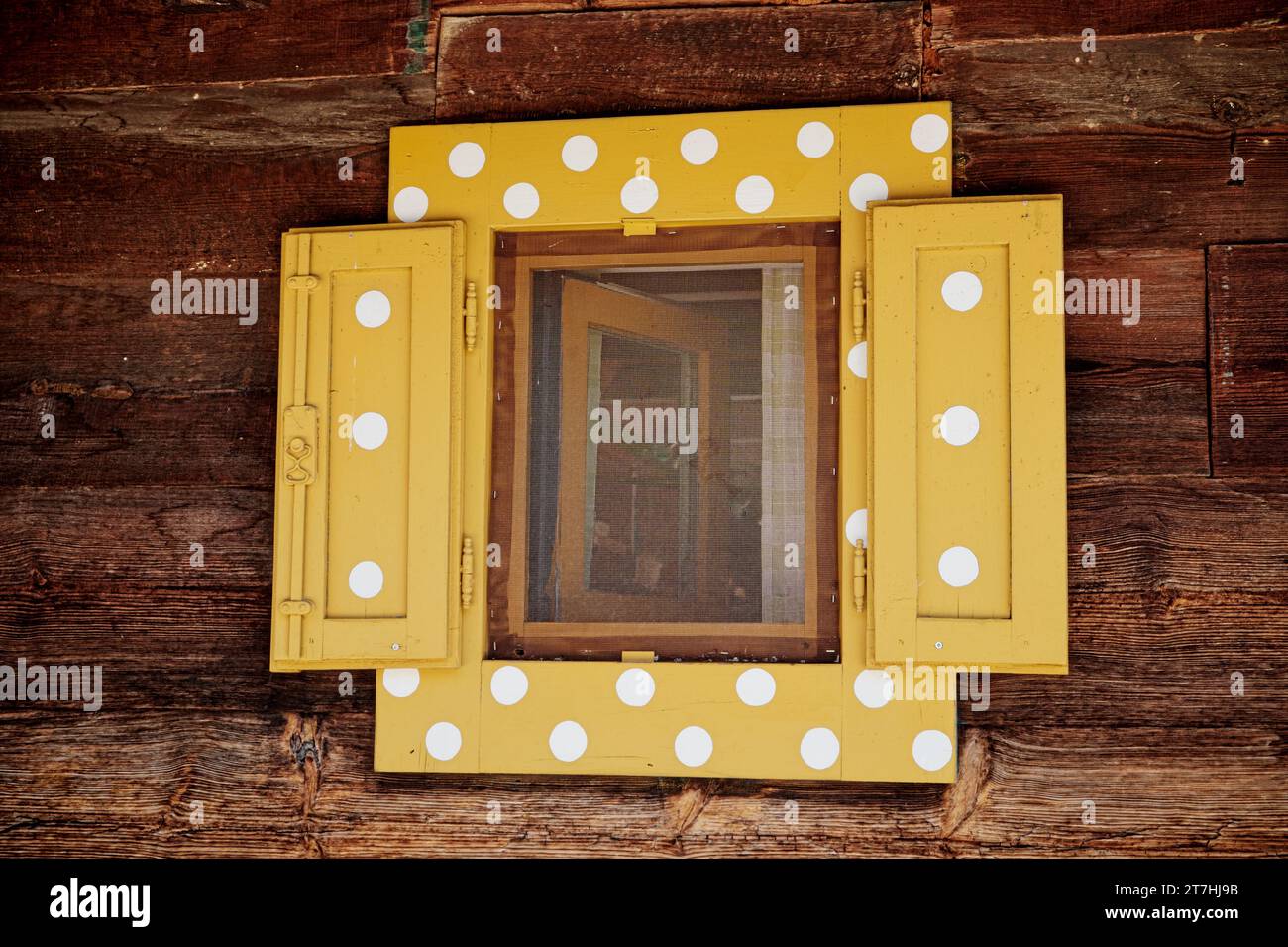 wooden ocher window decorated with white polka dots in Kustendorf ...