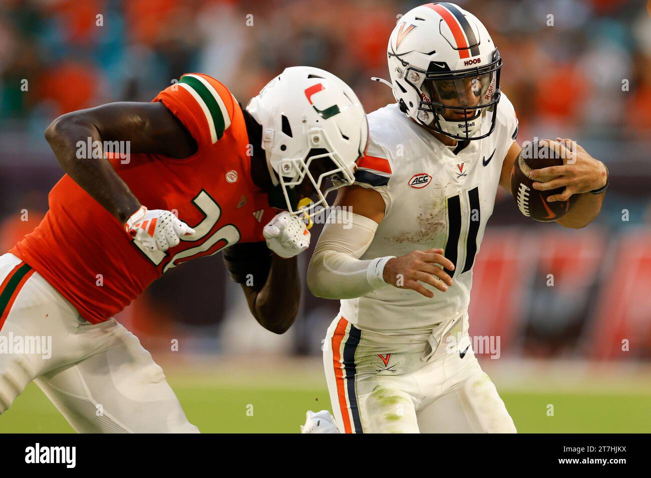 University of Virginia quarterback Tony Muskett (11) get's pushed out ...