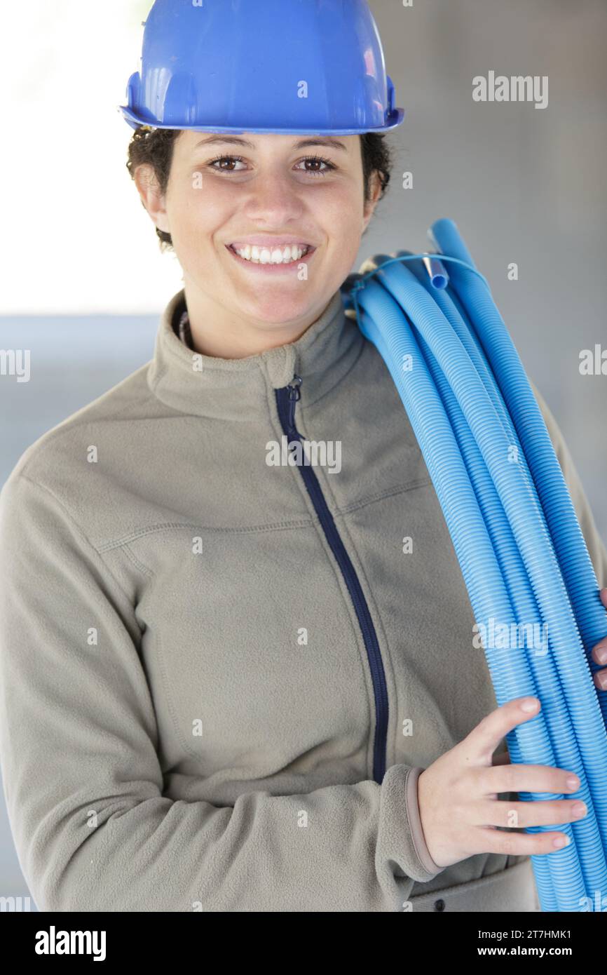 young woman in a work uniform smiles at camera Stock Photo - Alamy