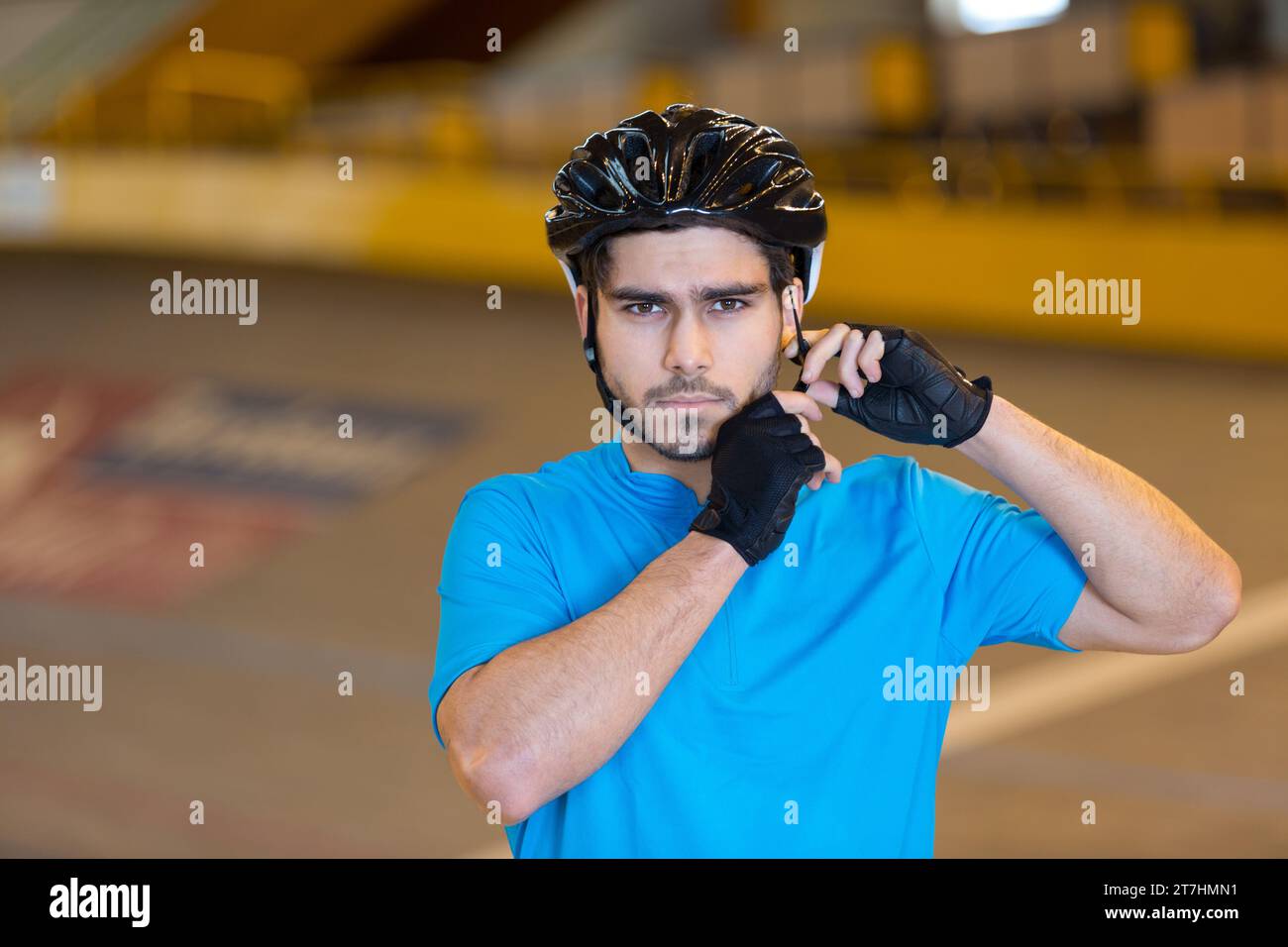 young male cyclist putting helmet Stock Photo - Alamy