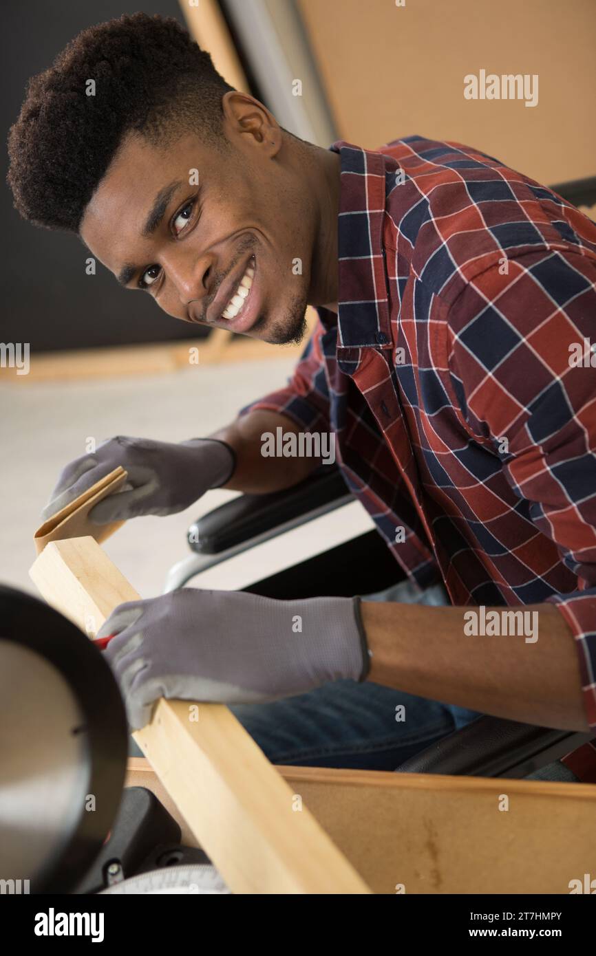 disabled carpenter rubbing down wood with sandpaper Stock Photo - Alamy