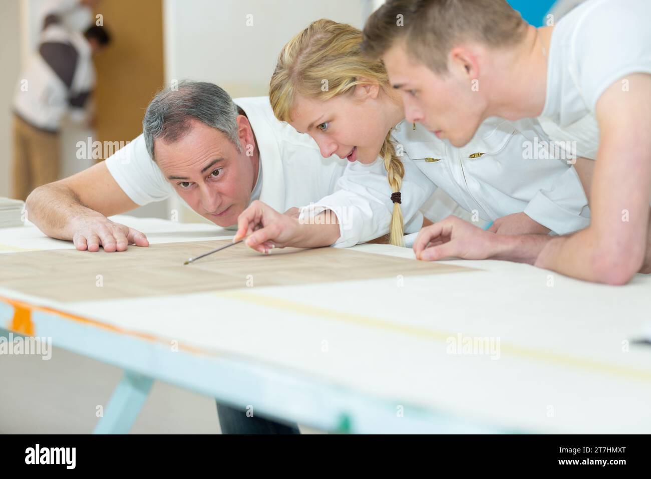 apprentice studying wallpaper design Stock Photo - Alamy