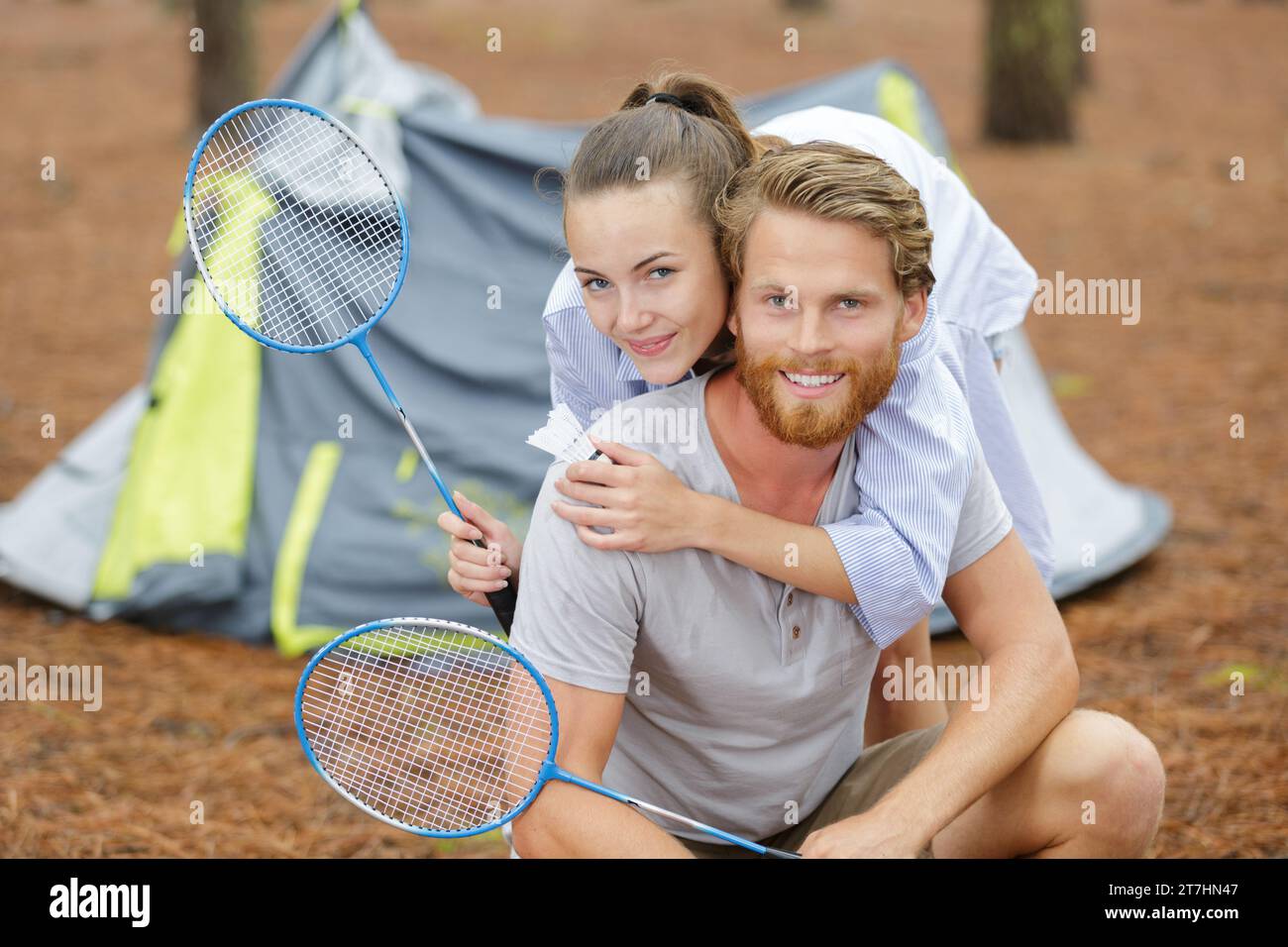 couple hugging with badminton rackets Stock Photo - Alamy