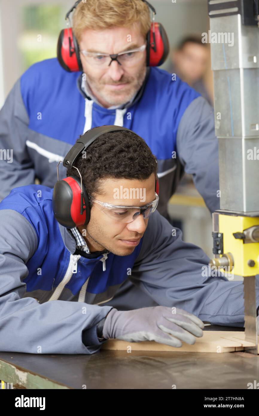 Young apprentice cutting timber hi-res stock photography and images - Alamy
