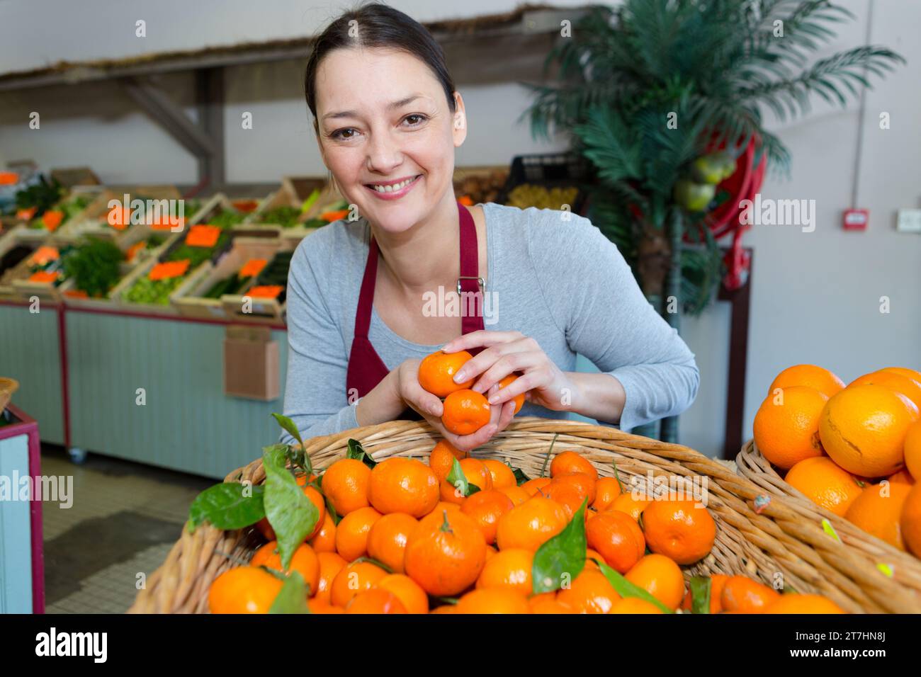 portrait of an orange female vendor posing Stock Photo - Alamy