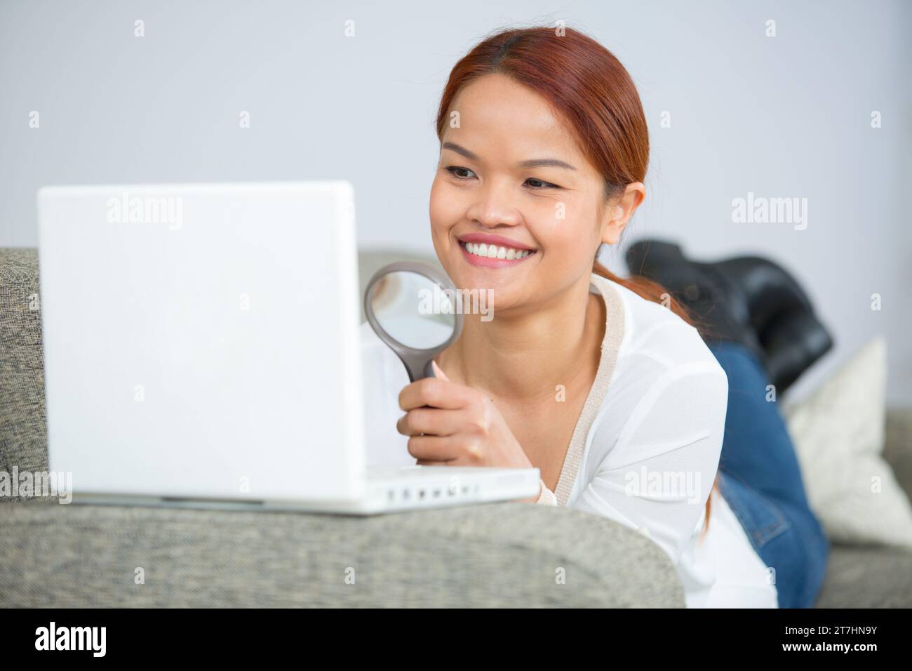 Woman looking laptop magnifying hi-res stock photography and images - Alamy