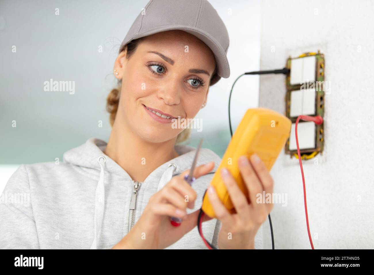 female electrician testing a wall socket Stock Photo - Alamy