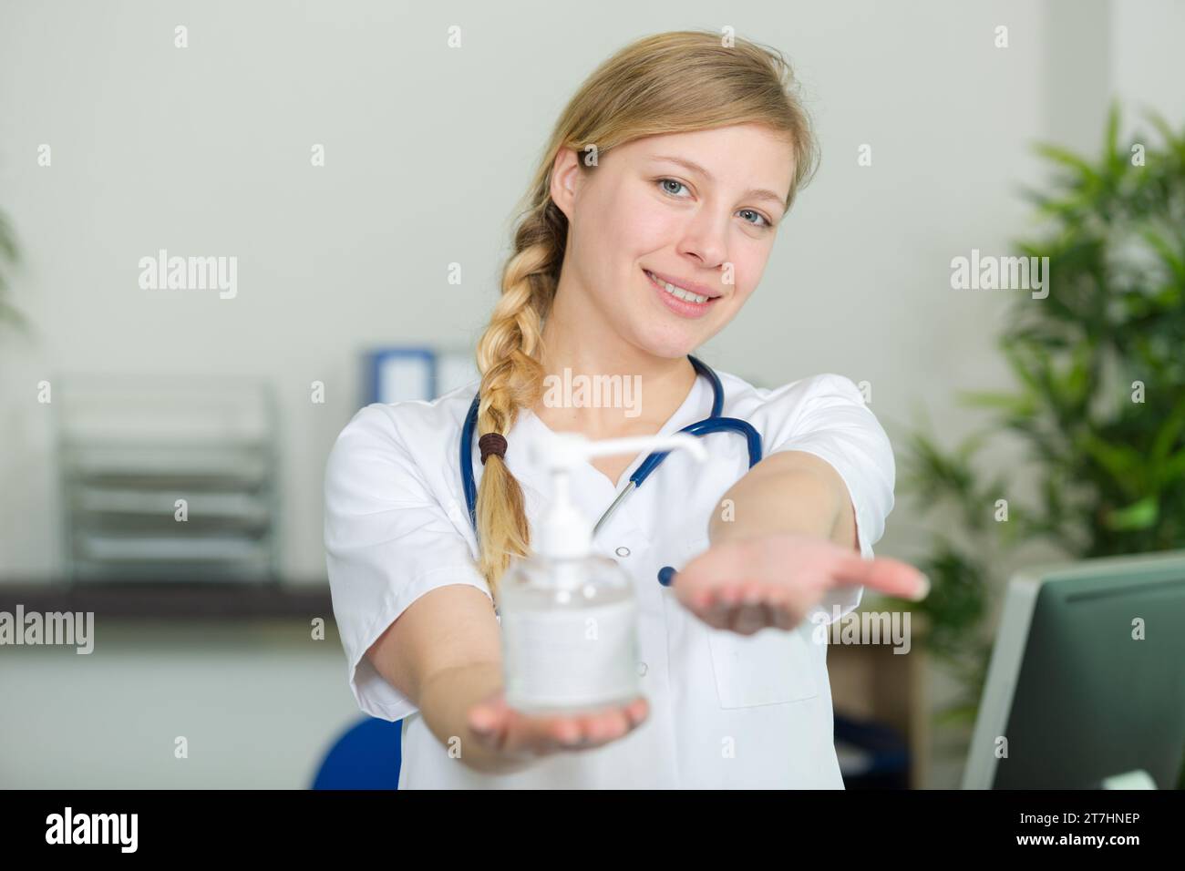 female nurse holding pump dispenser handwash Stock Photo - Alamy