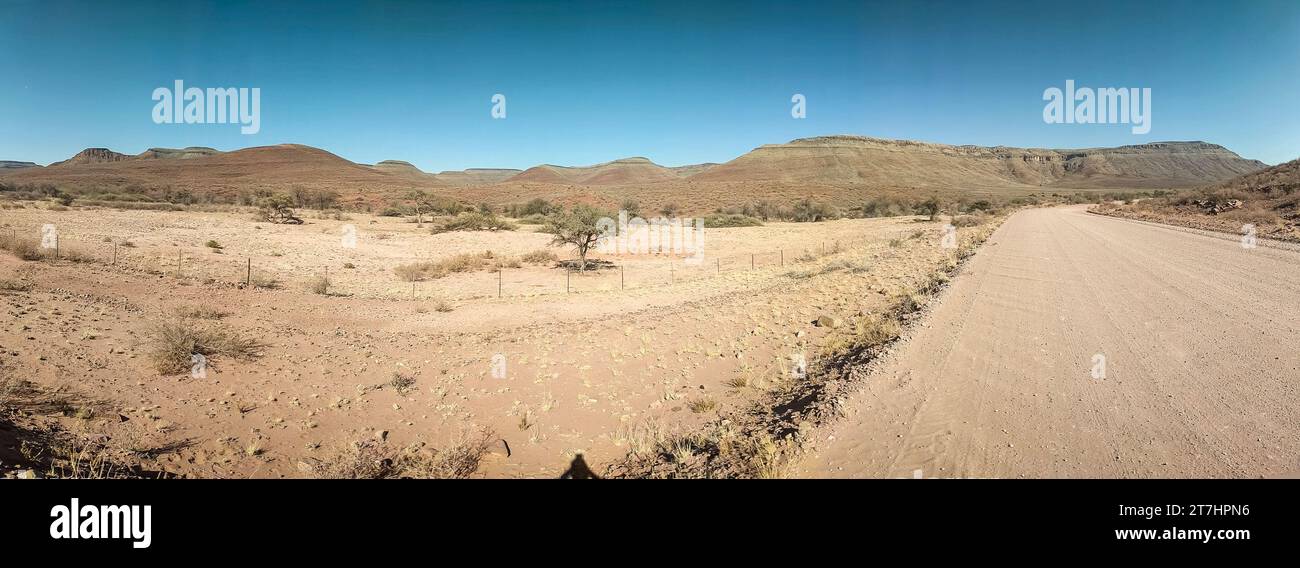 Panorama looking into the distance over a desert in Namibia, with ...