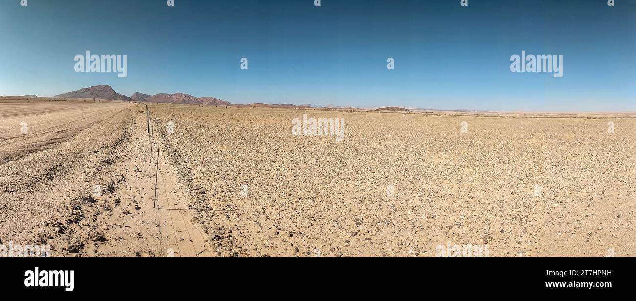 Panorama looking into the distance over a desert in Namibia, with ...