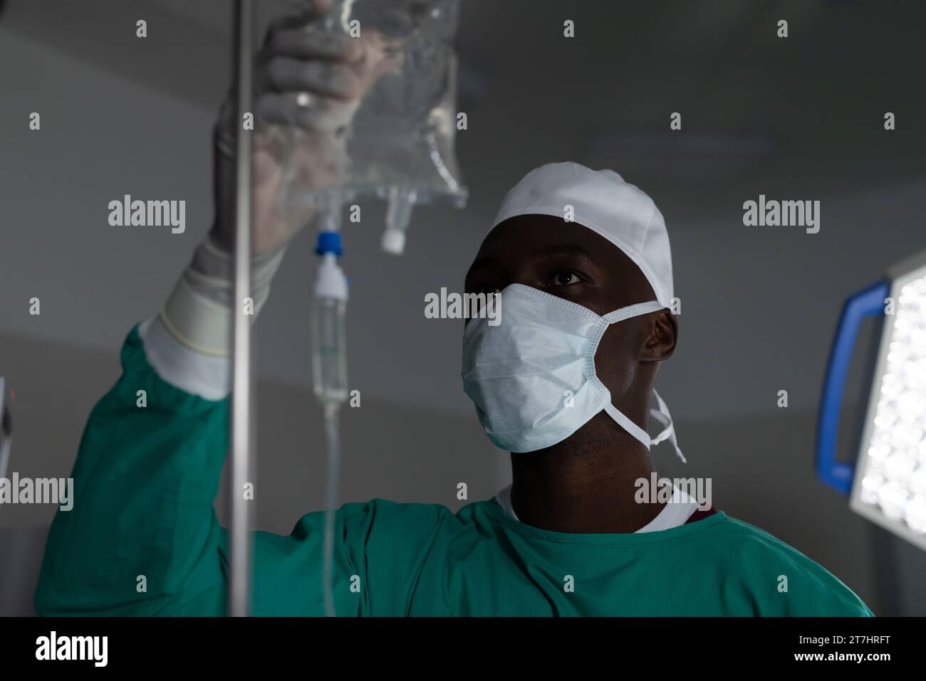 African american male surgeon applying drip in operating theatre at ...