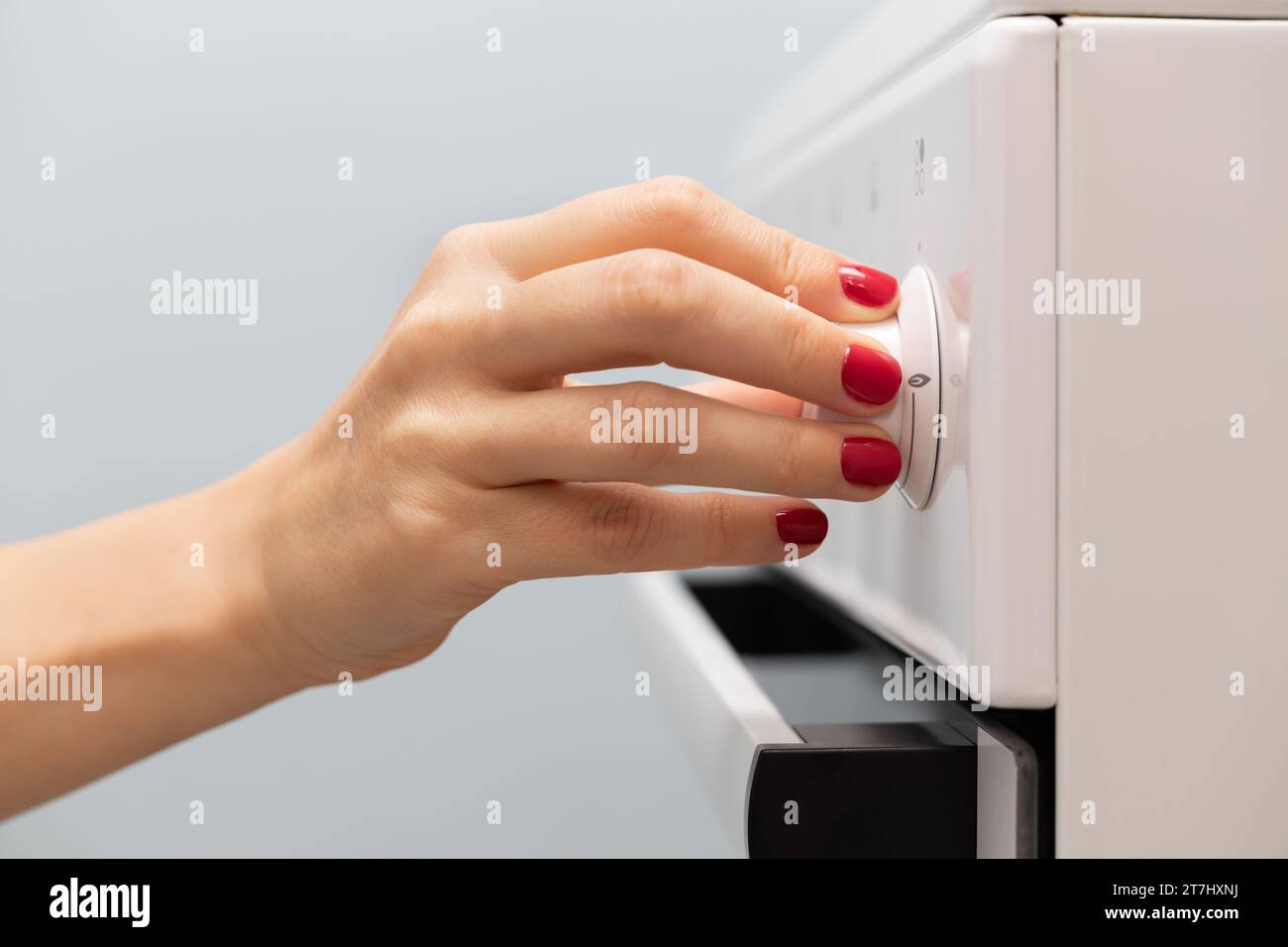 a woman's hand rotates the selector on a gas stove. woman's hand turns ...