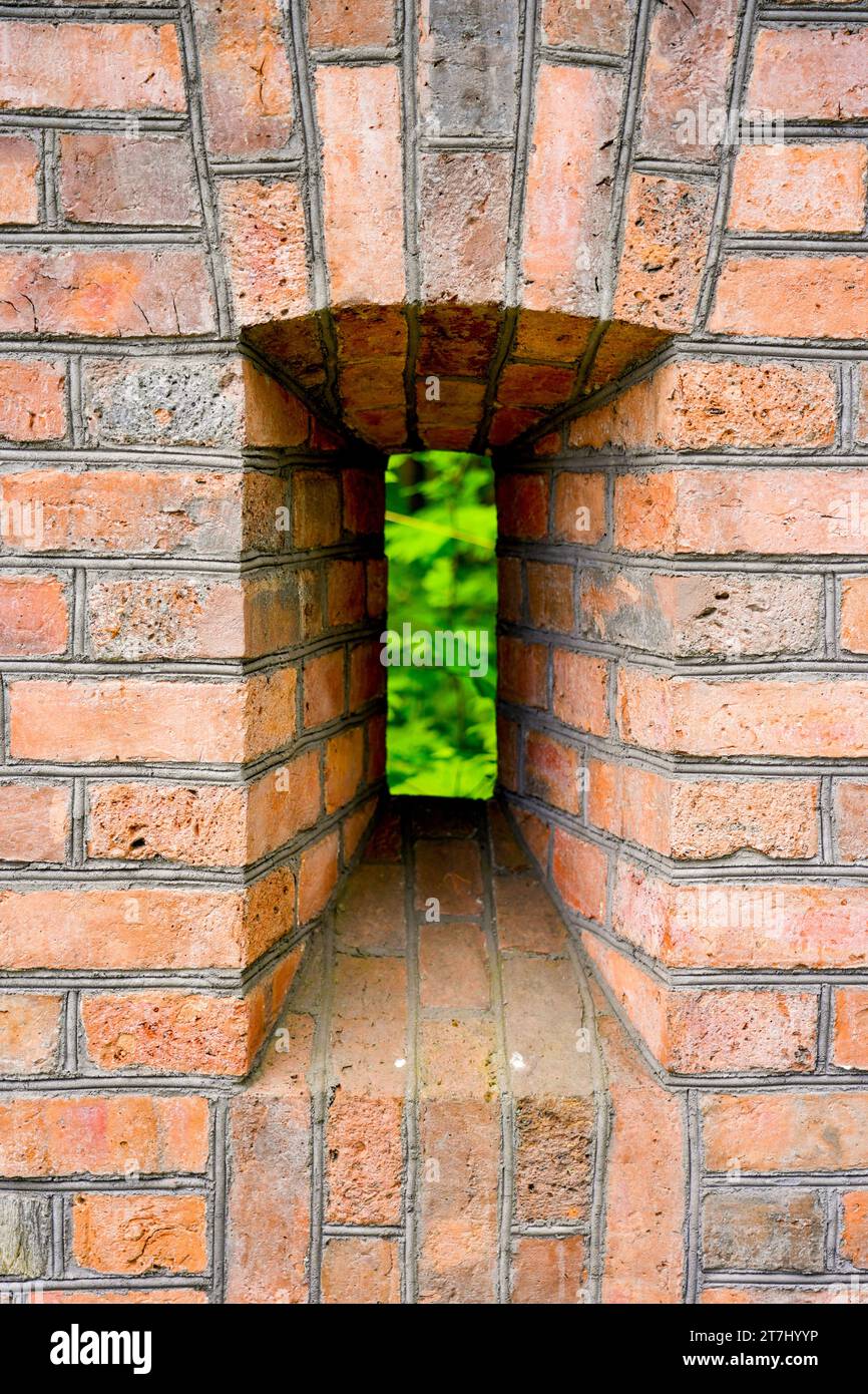 Embrasure on an old brick wall with a view of the greenery Stock Photo ...
