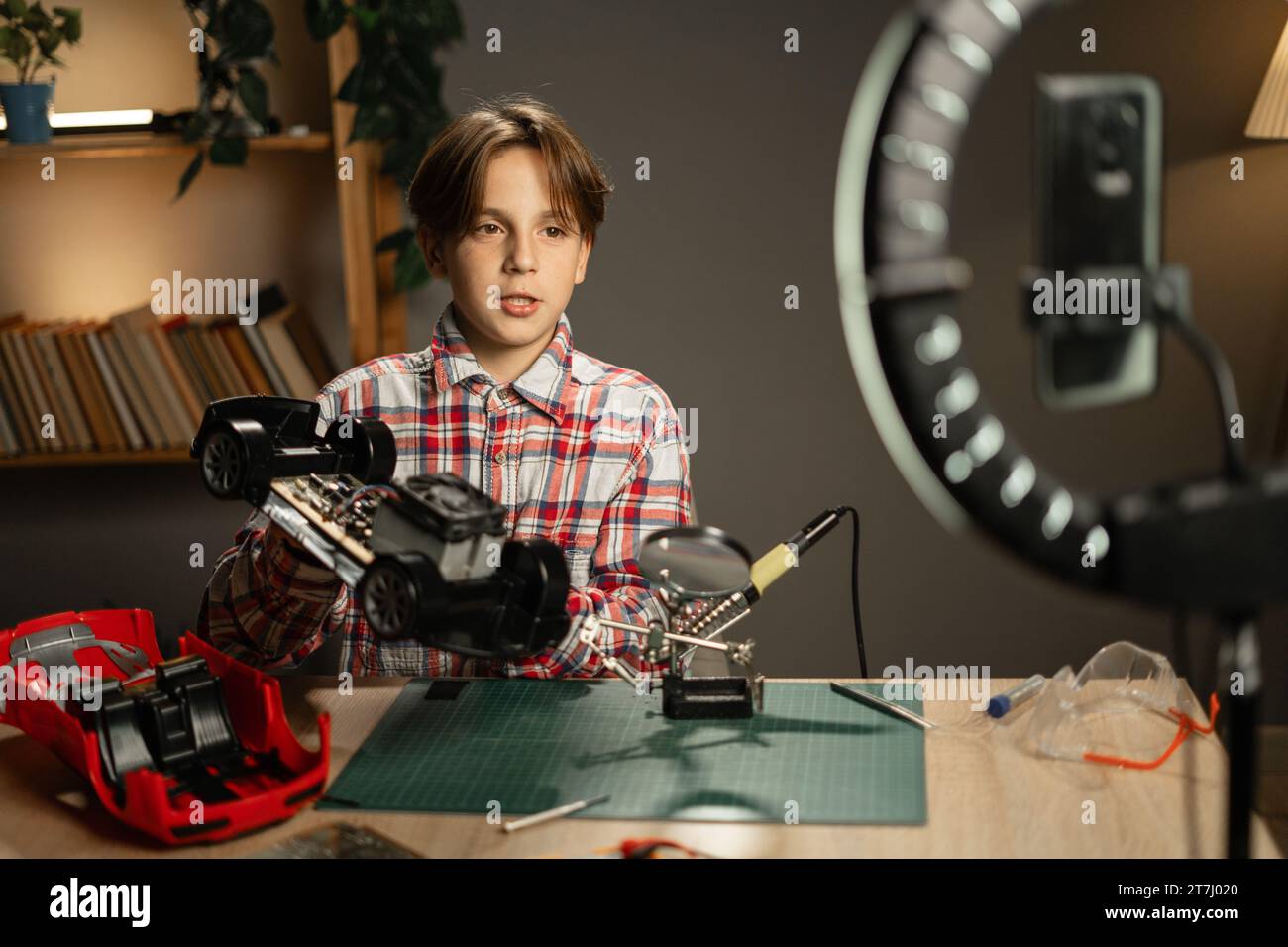 young blogger boy records social media videos at home, showcasing his ...