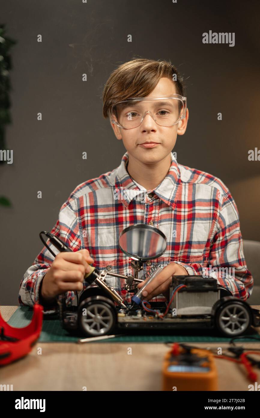 Boy spends time repairing the car, soldering electronics, improving the ...