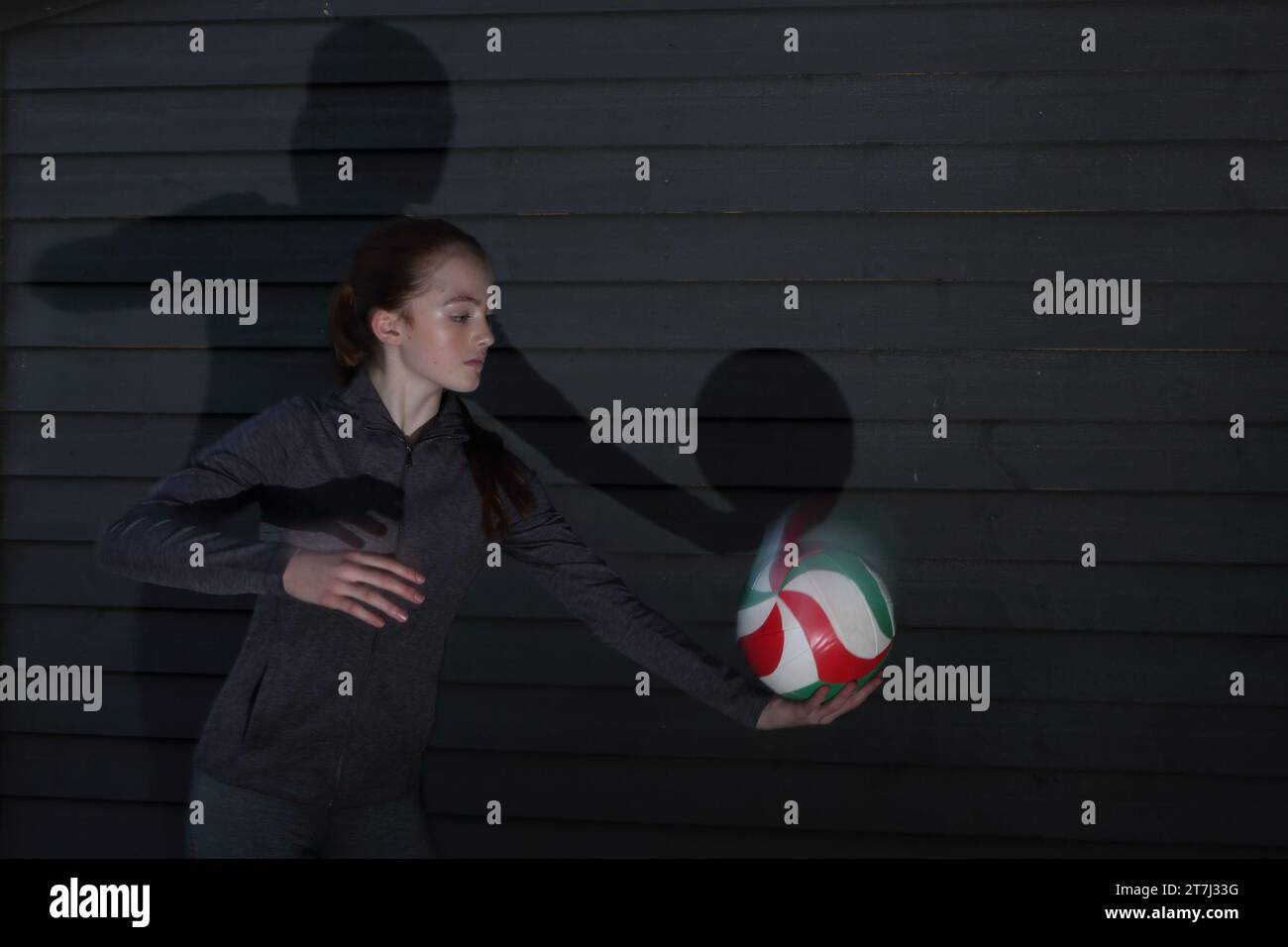 Teenage girl holding volleyball gets ready to serve Stock Photo - Alamy