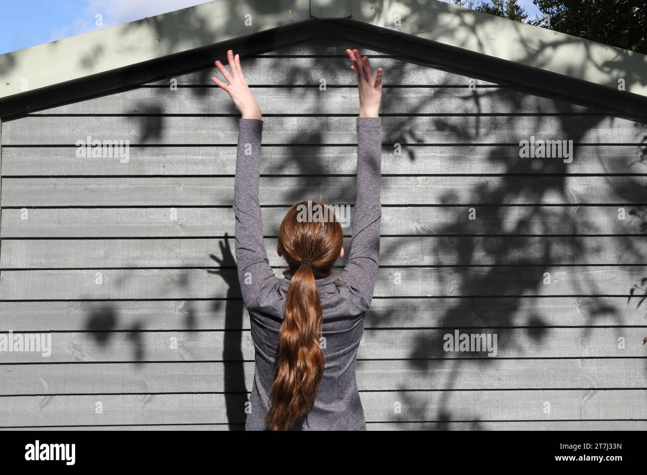 Teenage girl practises volleyball shots - ball out of shot after ...