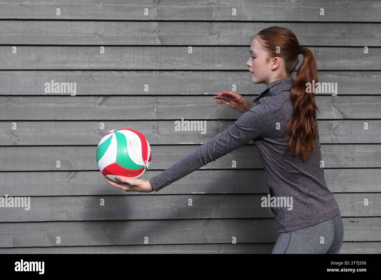 Teenage girl holding volleyball - getting ready to serve, showing ...