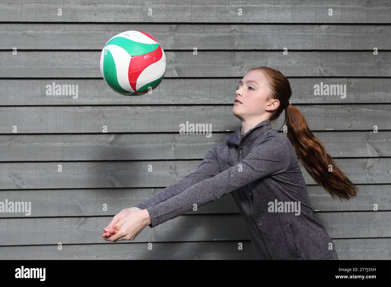 Teenage girl practises volleyball shots Stock Photo - Alamy