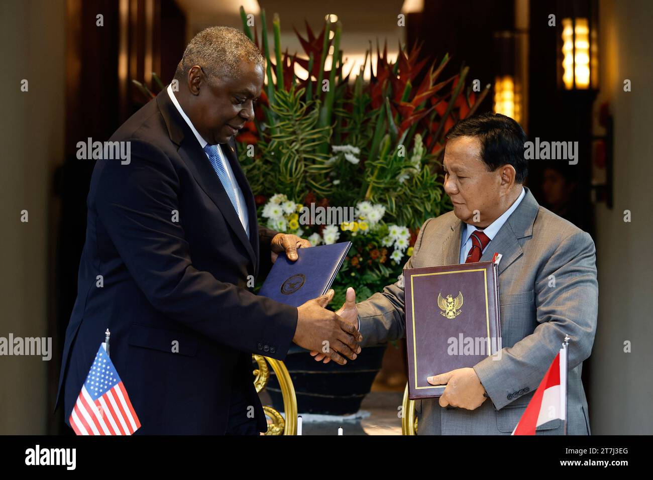 U.S. Secretary of Defence Lloyd Austin, left shakes hands with ...