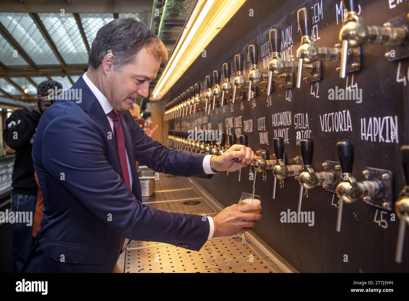 Prime Minister Alexander De Croo pours a beer from a multi tap at the ...
