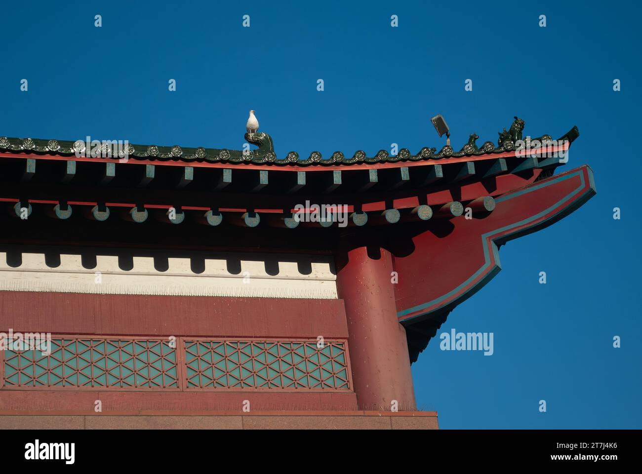 A red-colored, Asian-style Buddhist temple with a pigeon on it in Los ...