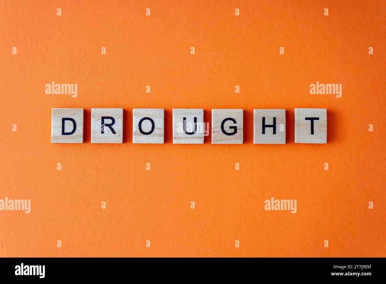 Drought word. The phrase is laid out in wooden letters top view. Orange ...