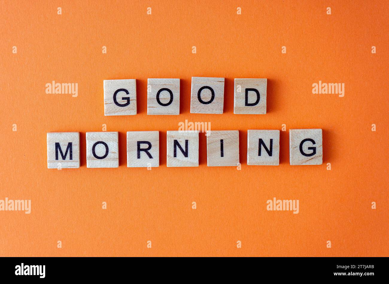 Good morning word. The phrase is laid out in wooden letters top view ...