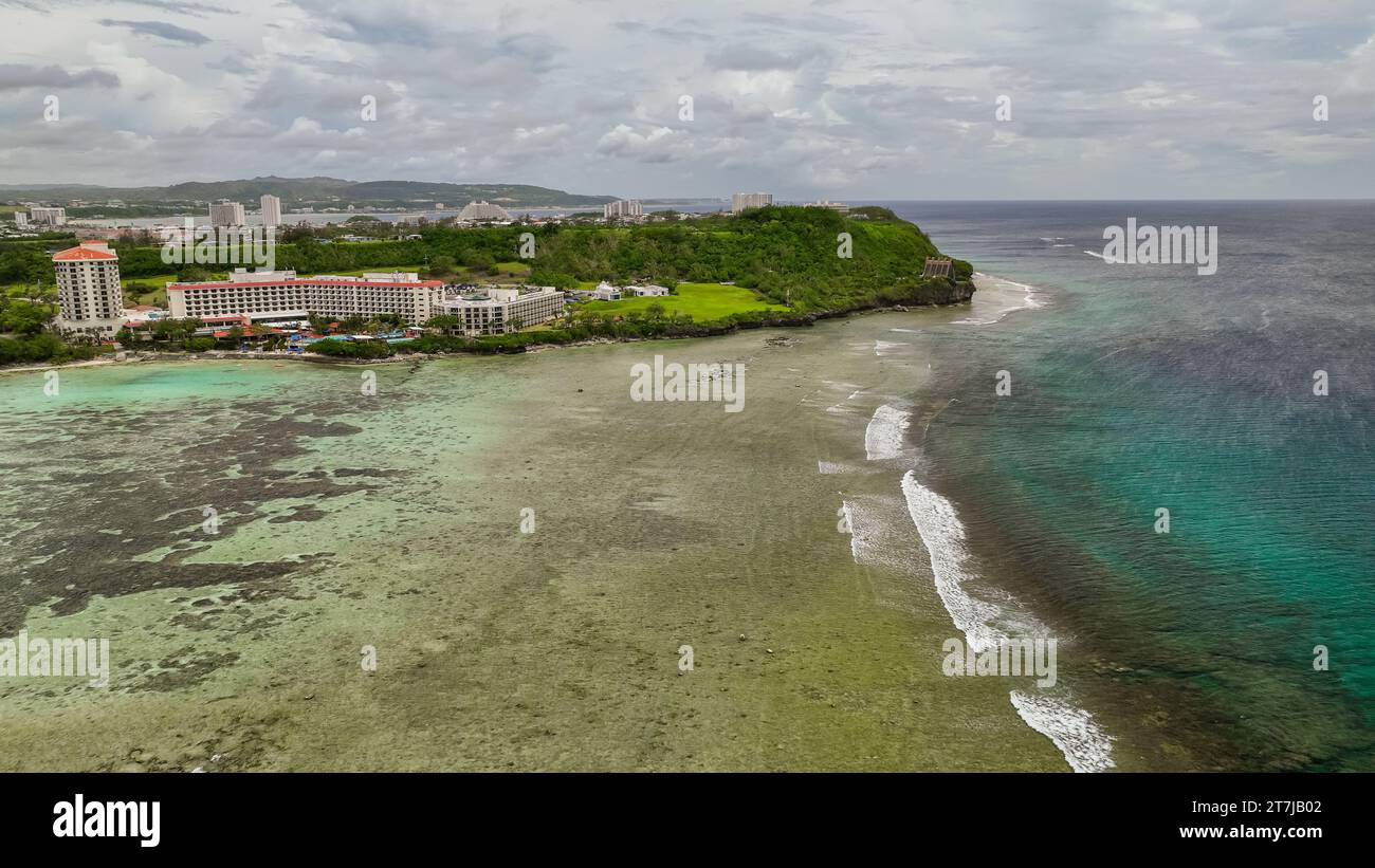 An aerial view of the vibrant buildings of Tumon Bay, Guam with a ...
