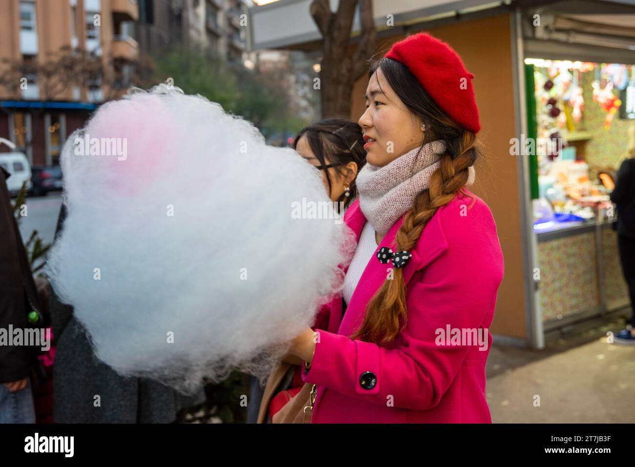 Radiant joy captured in a moment: An Asian woman savoring the sweetness ...