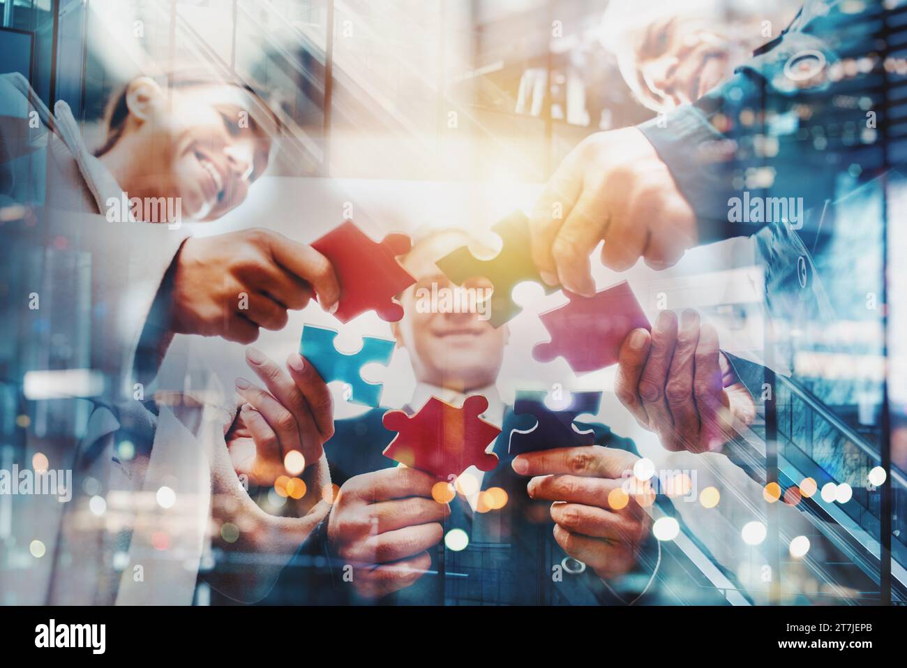 Businessmen working together to build a puzzle as teamwork, partnership ...